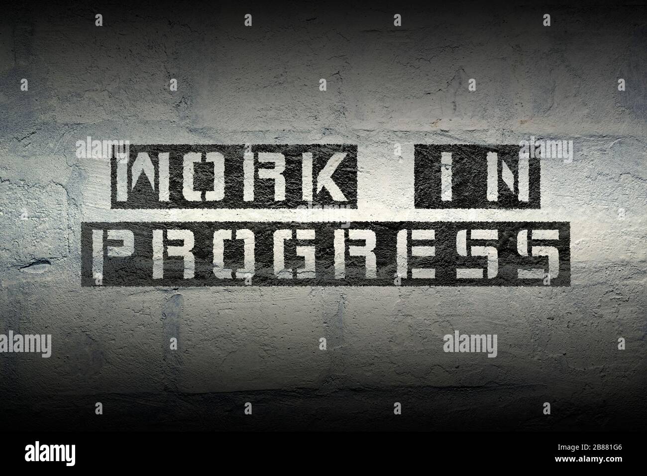 work in progress stencil print on the grunge white brick wall Stock ...