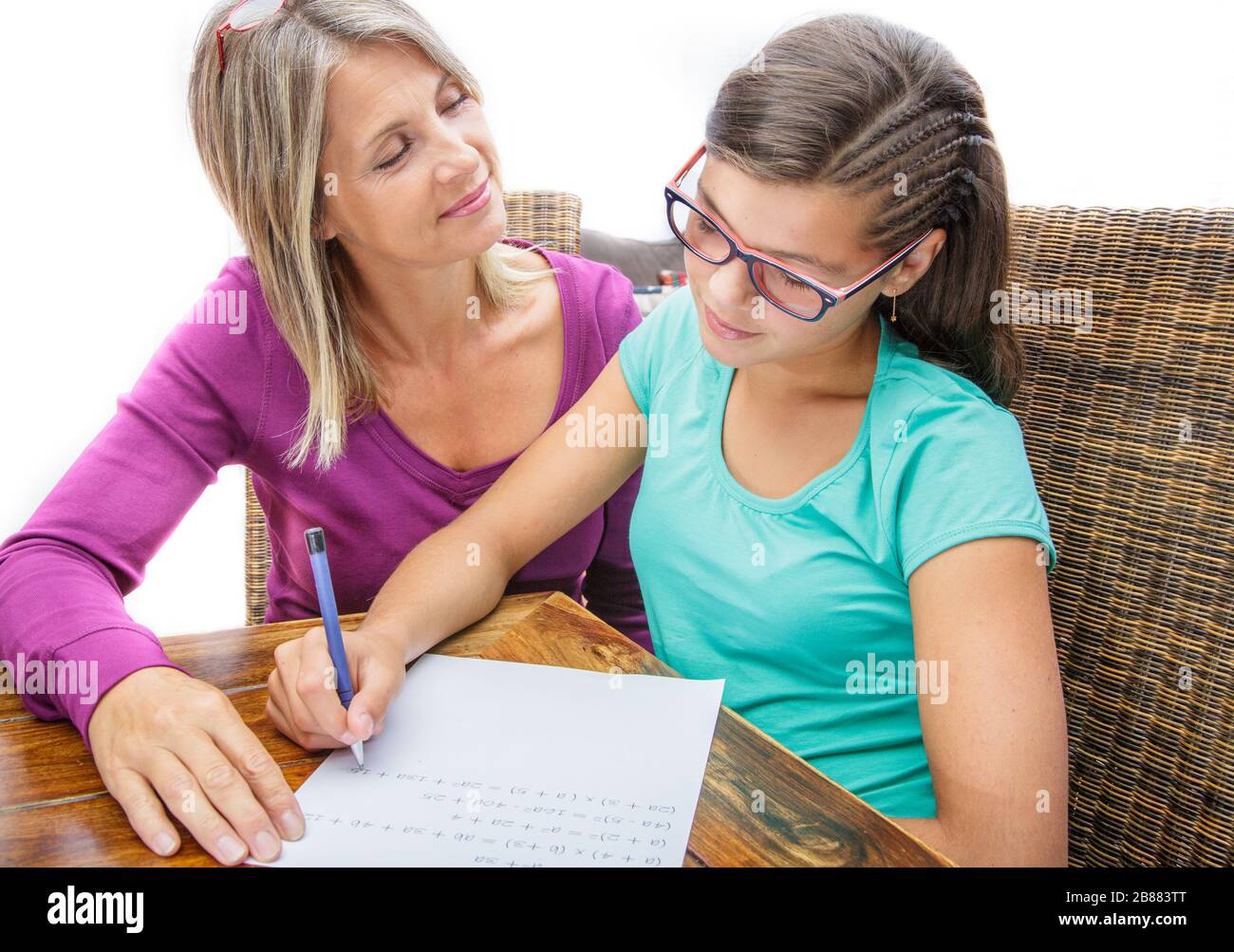 pretty teen girl doing its homework in complicity with a female teacher ...