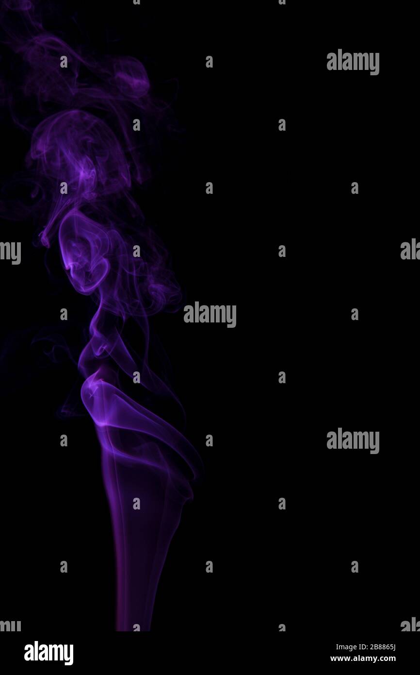 Abstract purple smoke swirling on a black background Stock Photo - Alamy