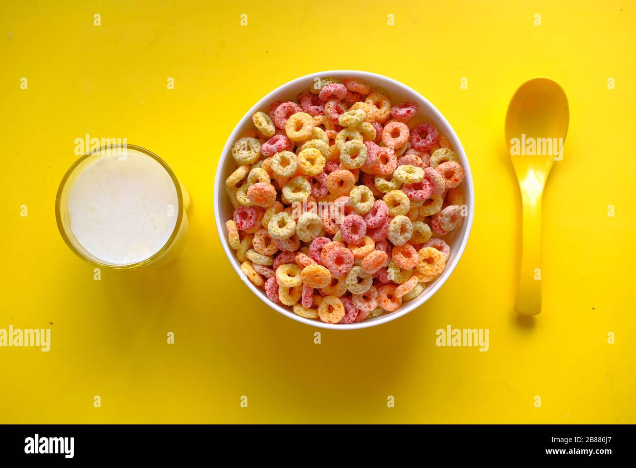 colorful ring corn flakes in a bowl on yellow background Stock Photo ...