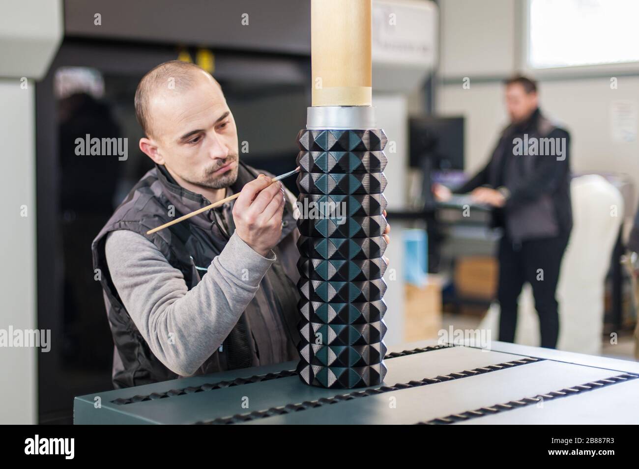 Technician doing post production, finishing and processing of the large ...