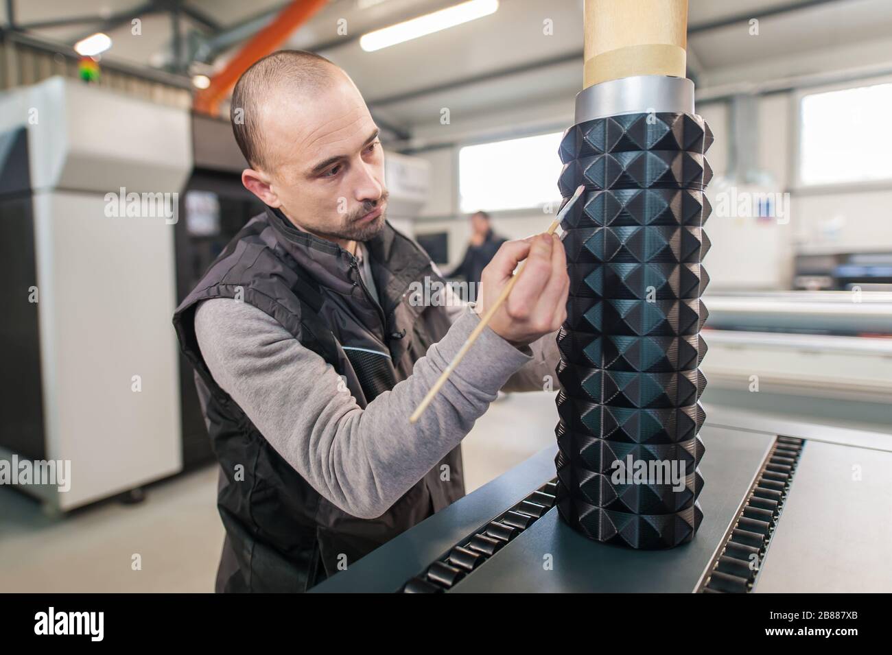 Technician doing post production, finishing and processing of the large ...