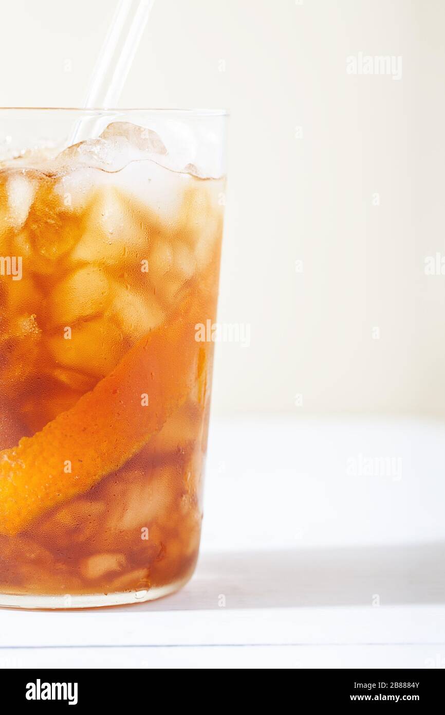 Cold brew coffee mocktail with orange peel close-up.Glass with citrus ...