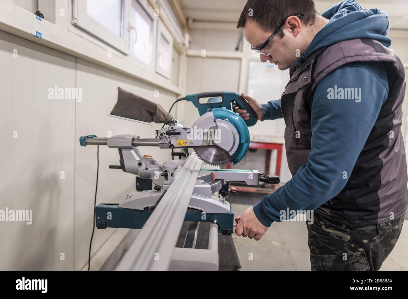 Worker technician works with electric wheel grinding on steel structure ...