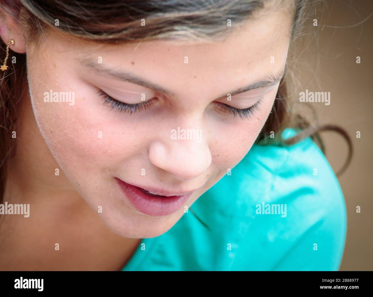closeup of a pretty young girl looking down Stock Photo - Alamy