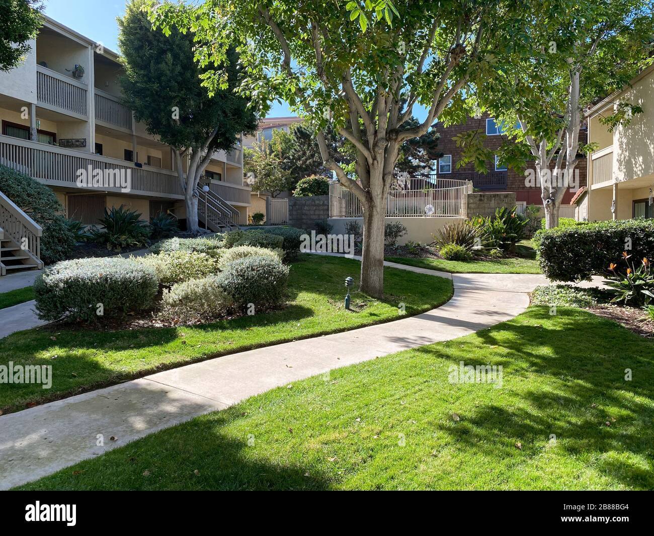Garden and lawn along the walk path through the typical condo complex ...