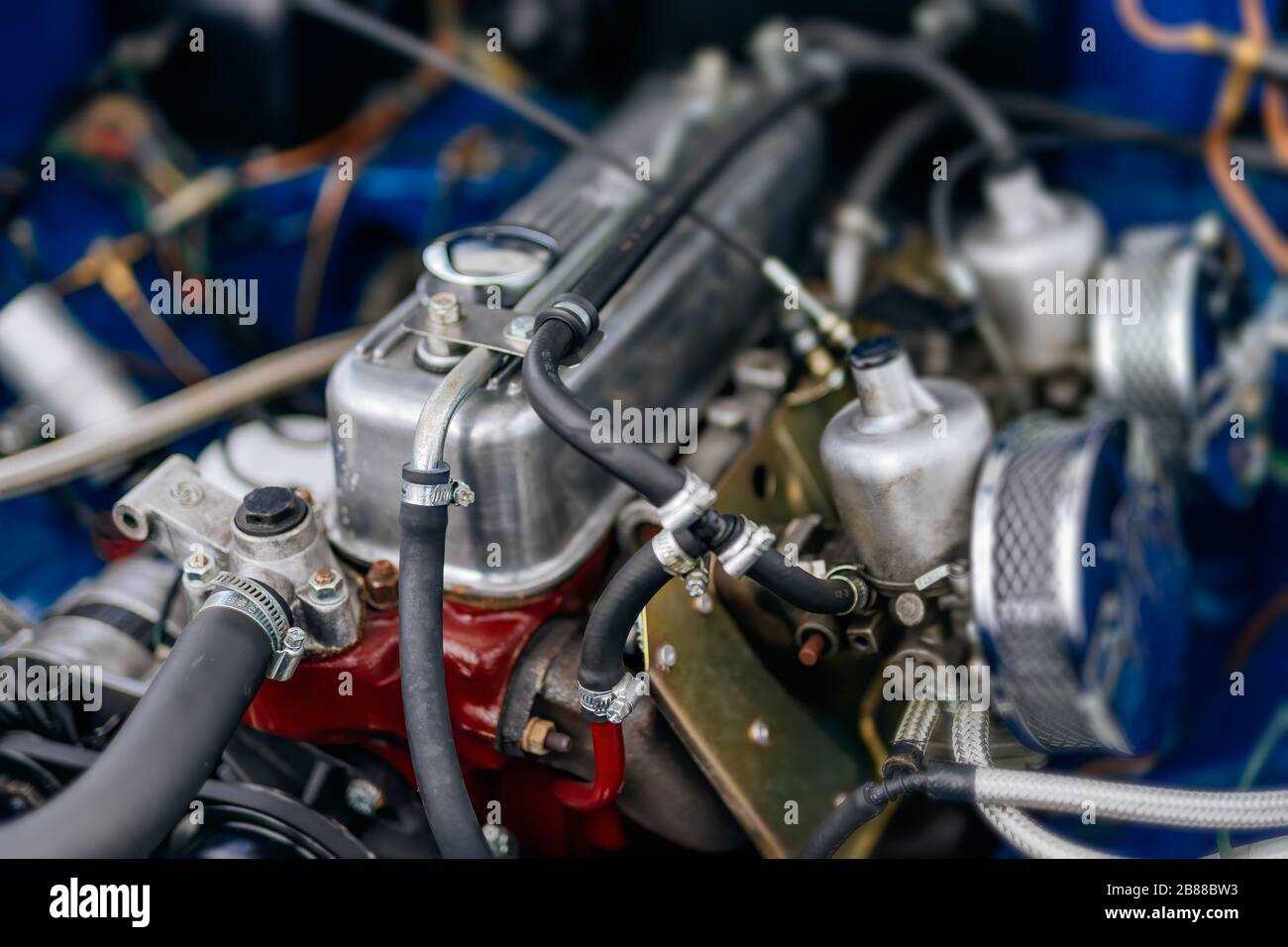 Close up with selective focus on vintage car engine block under open ...