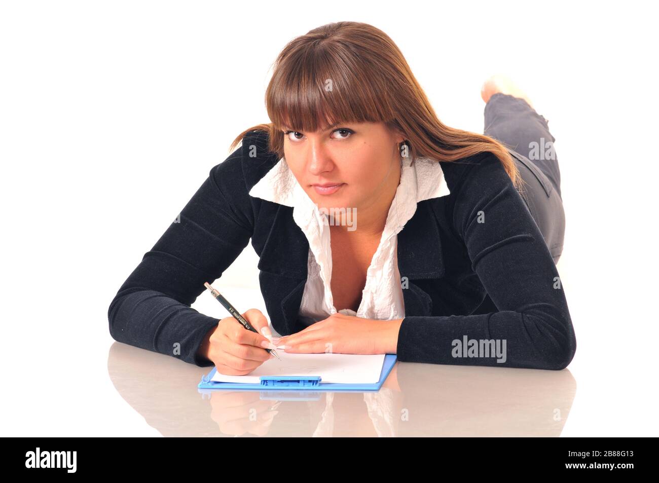 Beautiful caucasian white brunette woman lying holding pen and take a ...