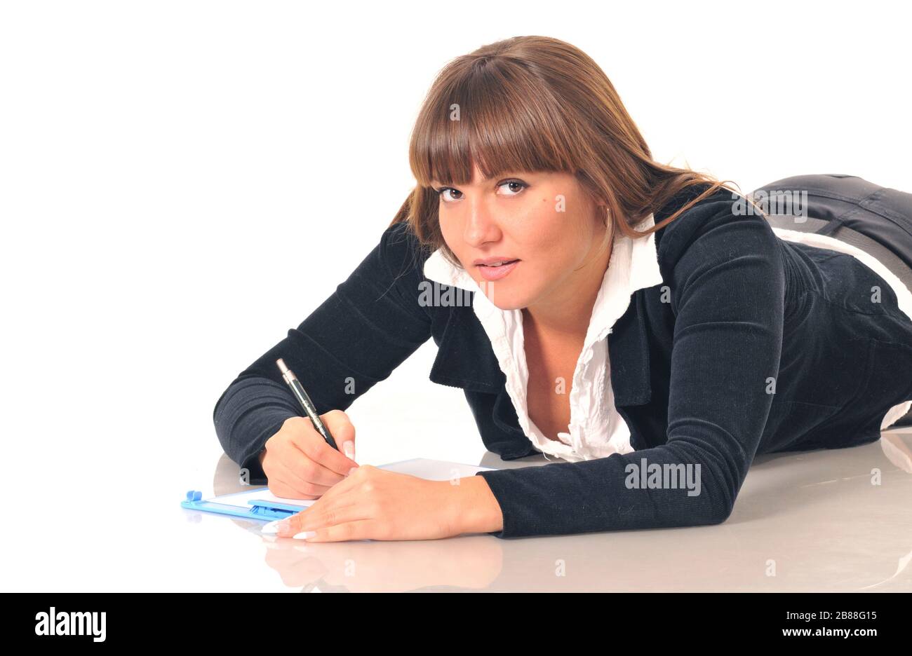 Beautiful caucasian white brunette woman lying holding pen and take a ...