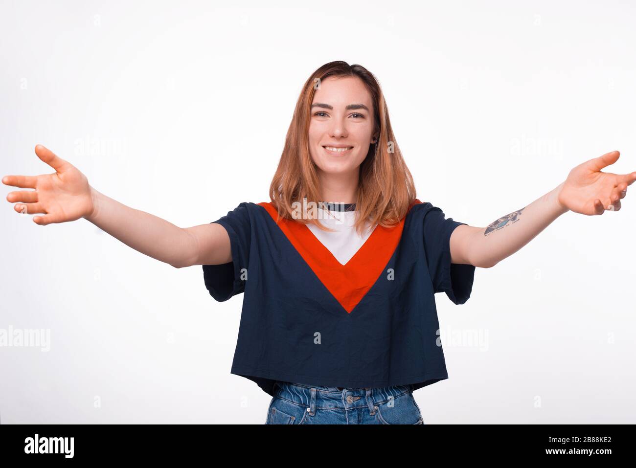 Photo of charming young hipster woman making welcome gesture, open ...