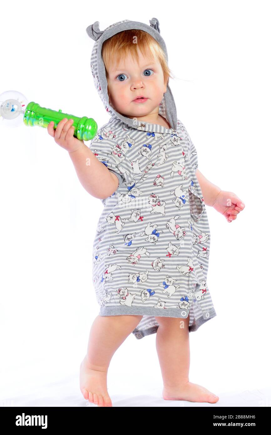 Little cute baby boy in diapers playing with child toy holding it in ...