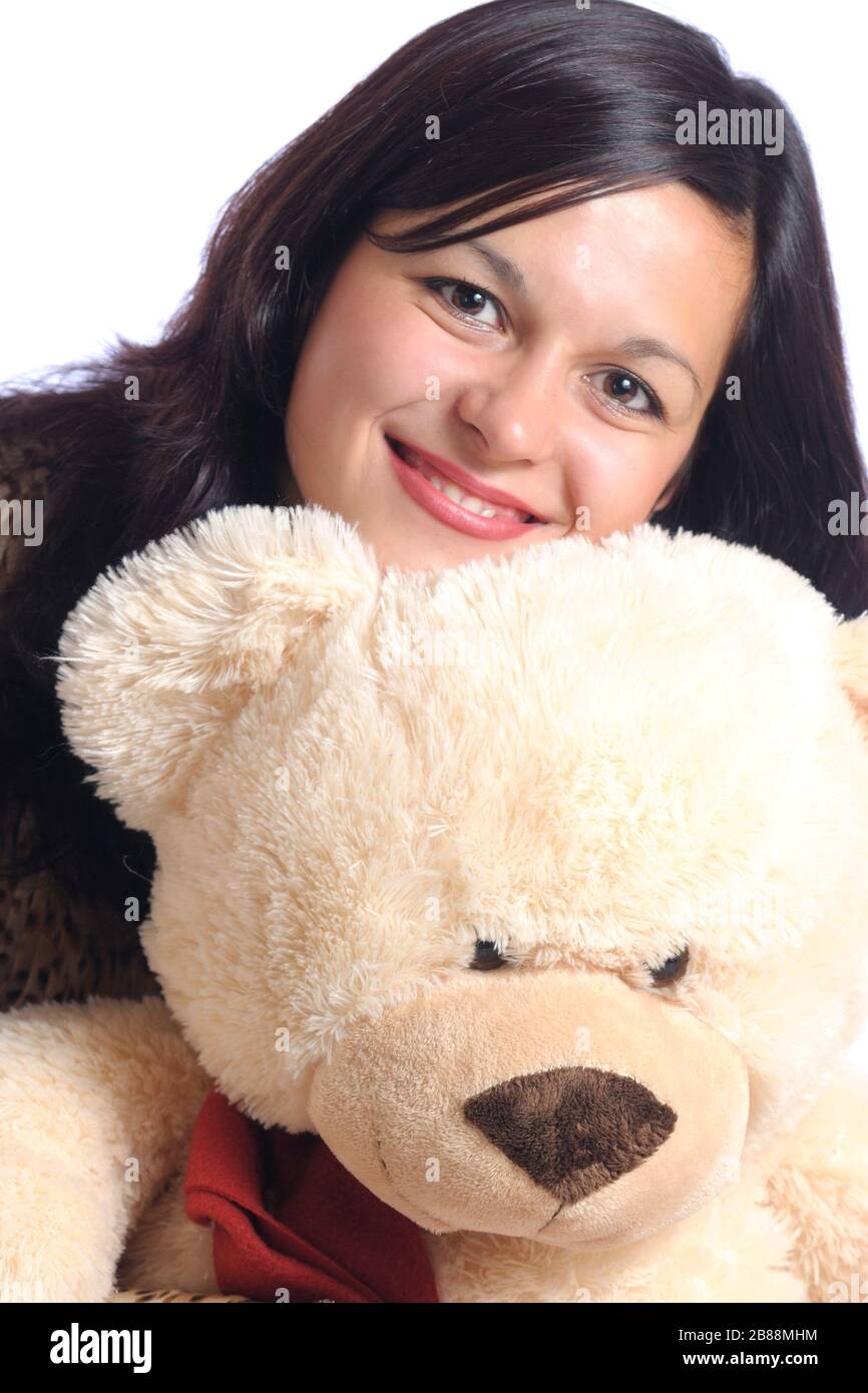 Portrait of pretty european brunette woman with teddy. Attractive girl ...
