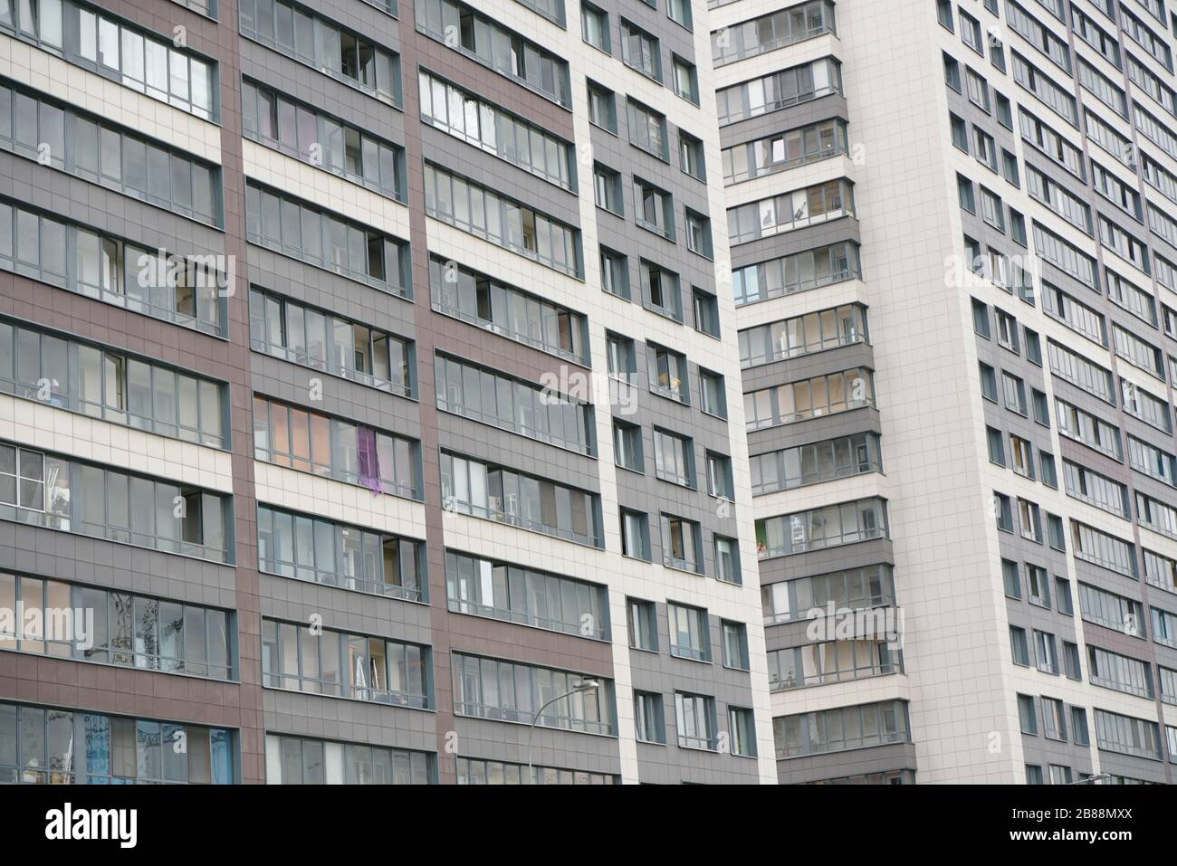 Frontal view of facade of building with a lot of windows. modern city ...
