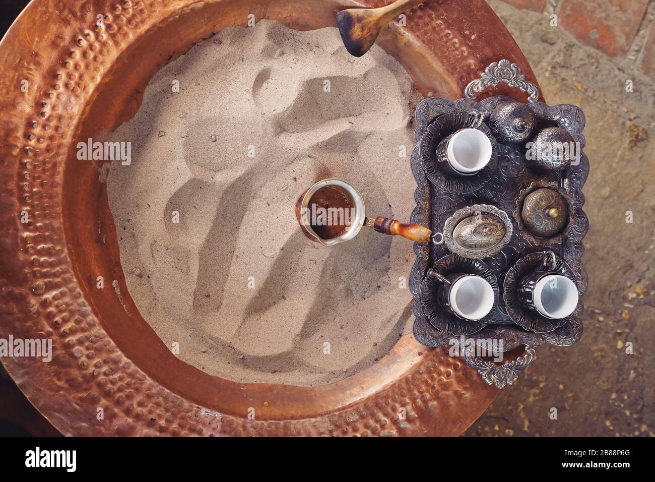 Turkish coffee brewing process in the sand and elderflower syrup ...