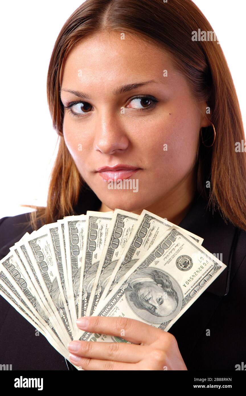 Portrait of a serious young woman holding money banknotes isolated ...