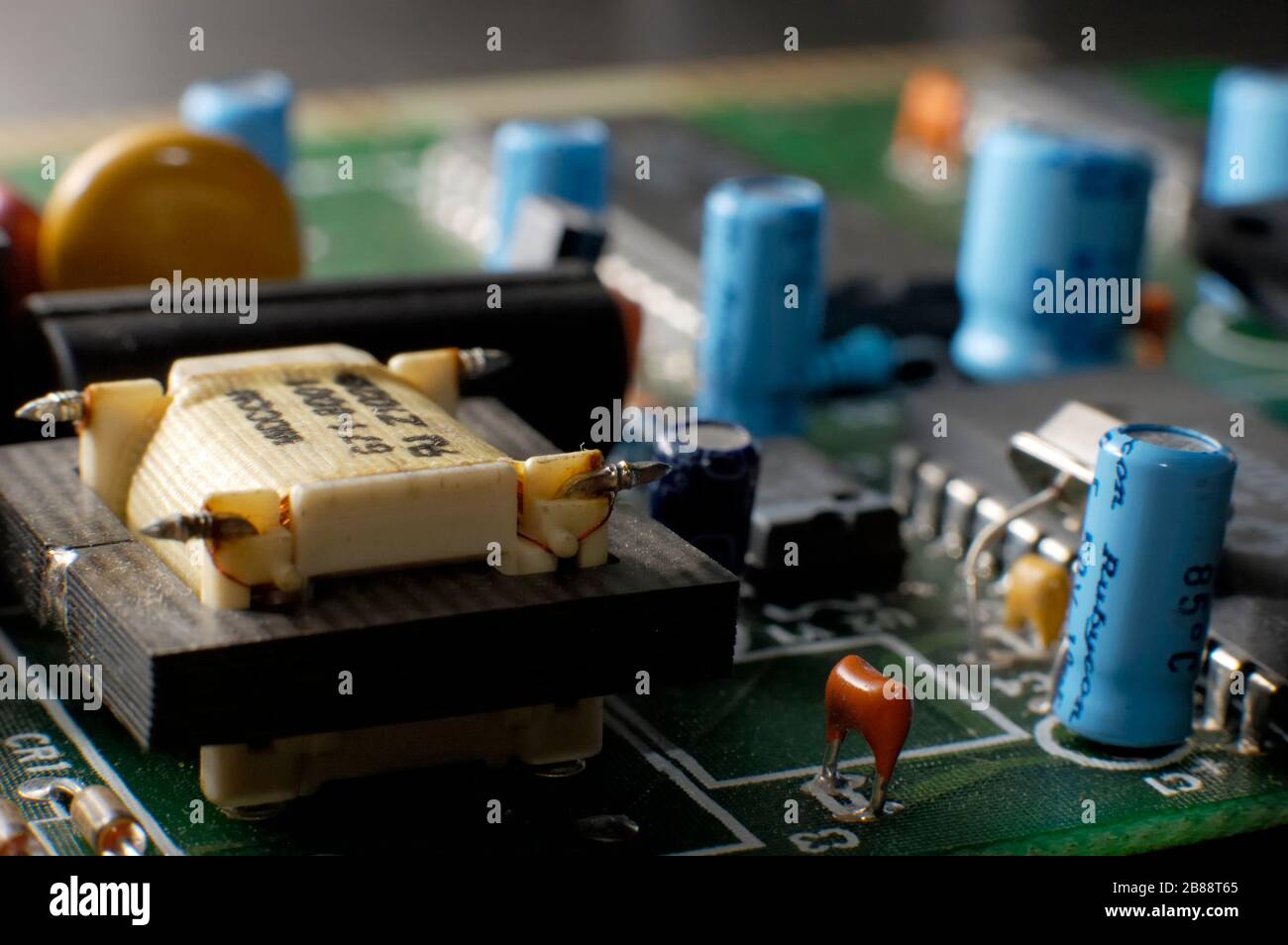 Close up green modem board with transfotmer lies on the table. Computer ...