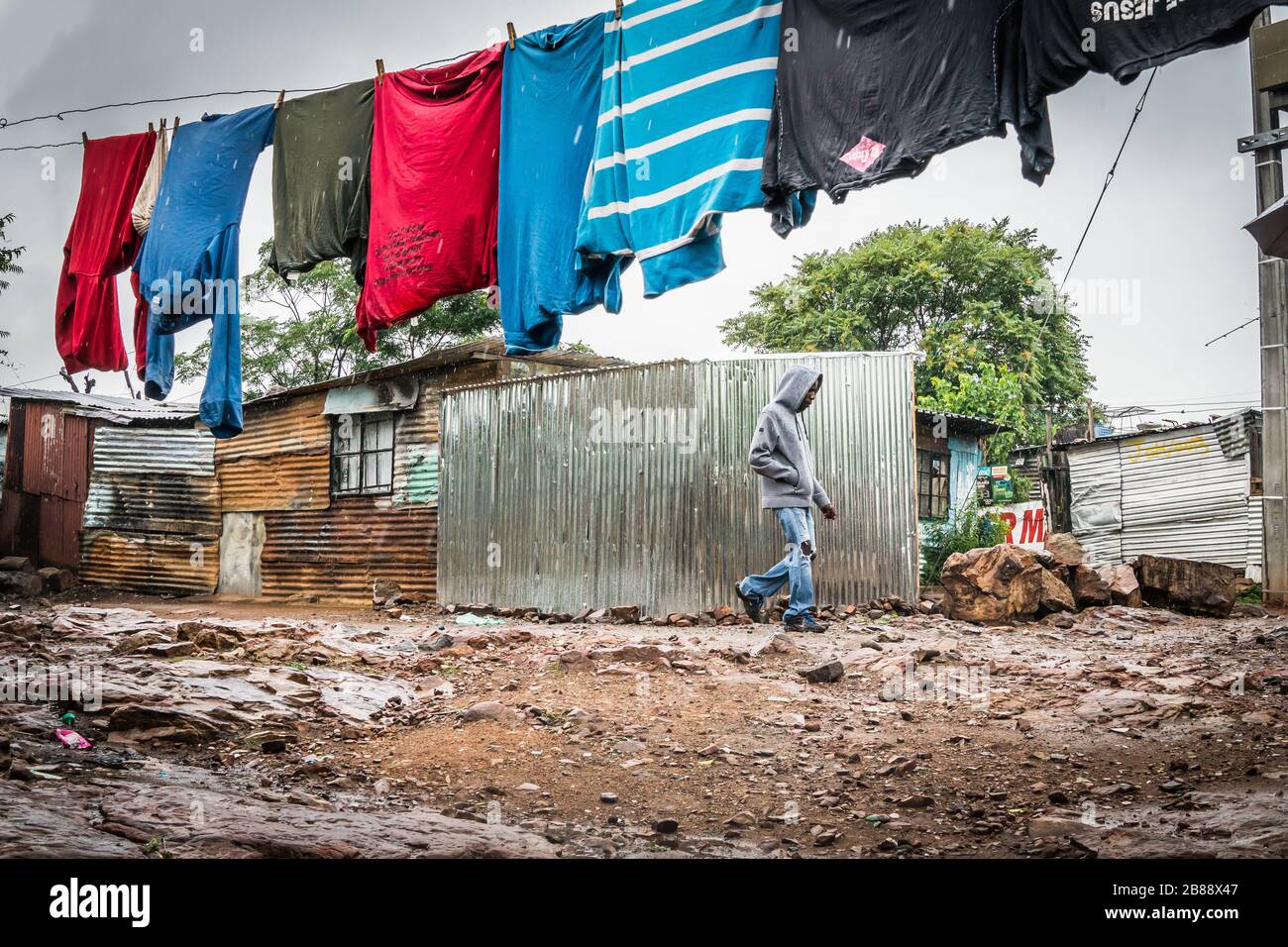 Johannesburg, South Africa - December 4, 2019 - a man walks in the rain ...