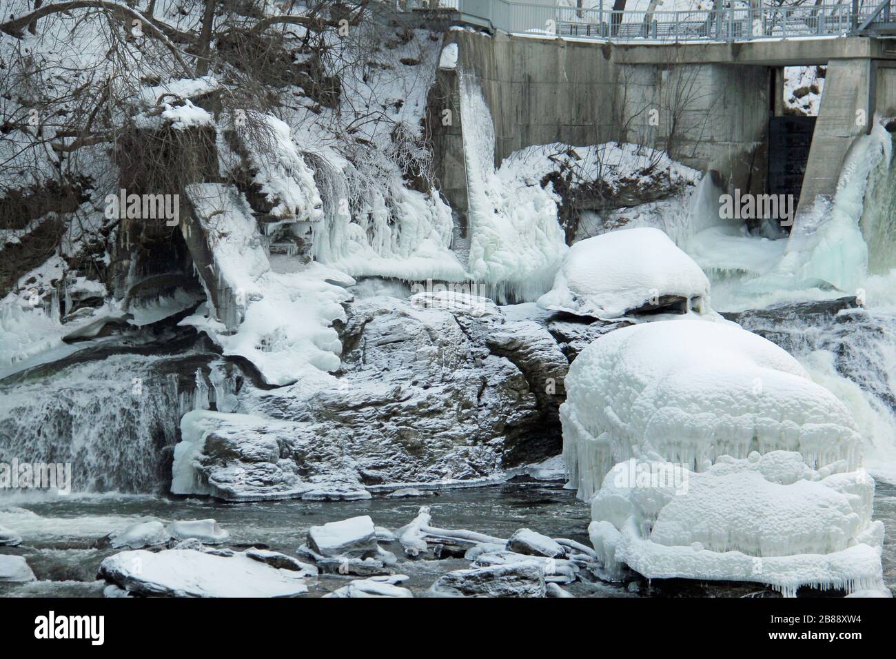 Frozen waterfall flow from an electrical barrage with overflow of water ...