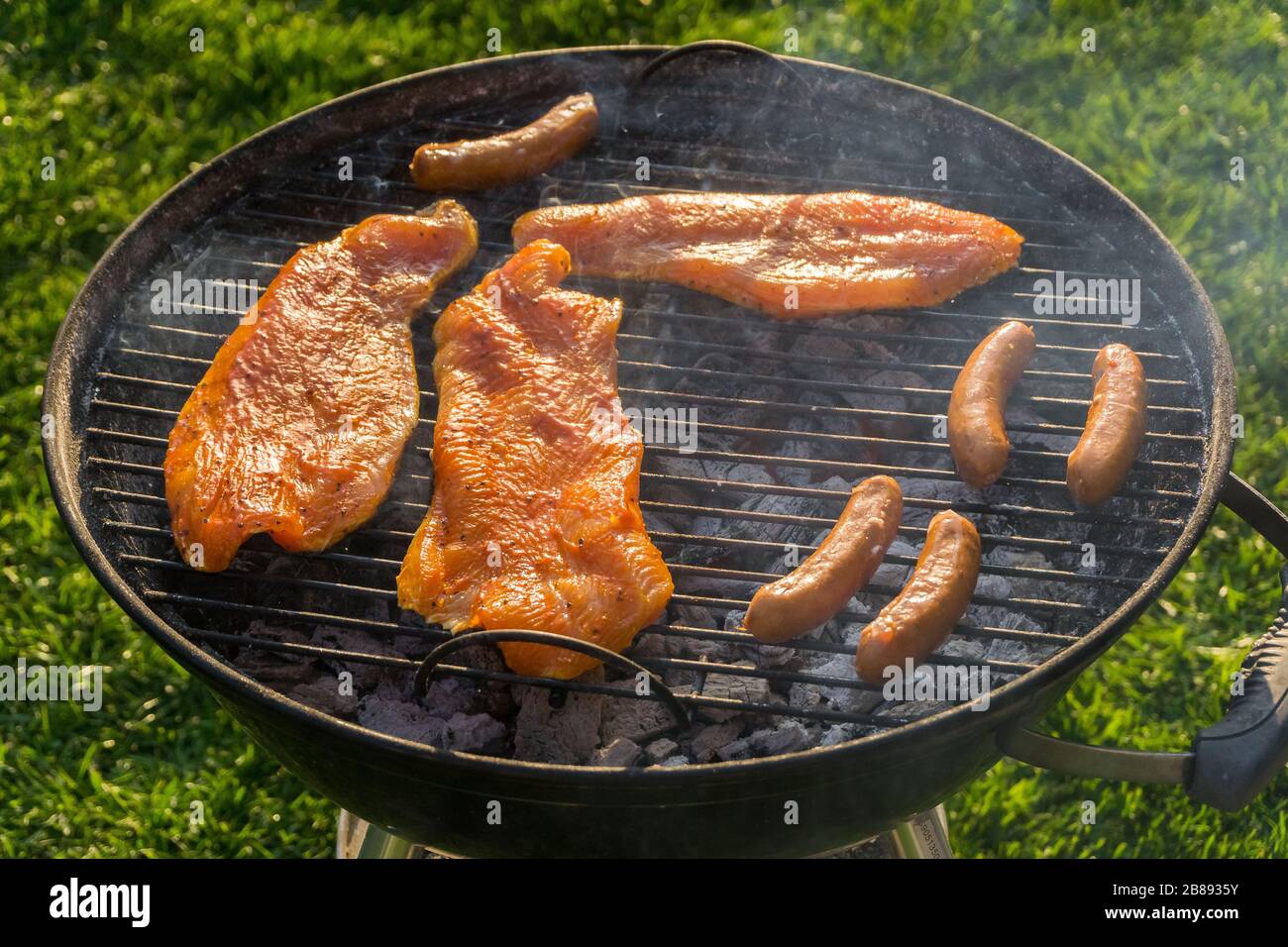 Meat on a charcoal grill at a barbecue Stock Photo - Alamy