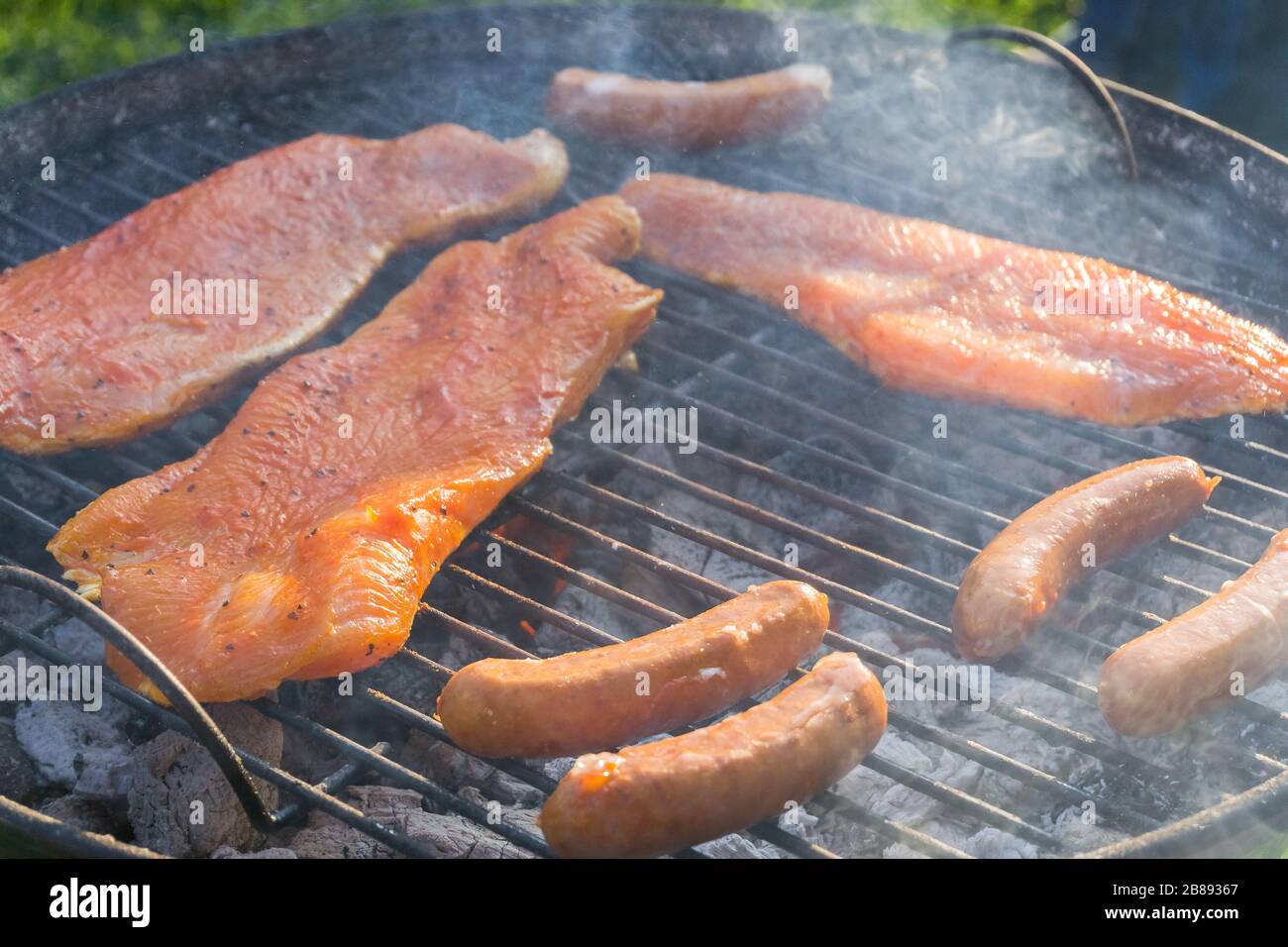 Meat on a charcoal grill at a barbecue Stock Photo - Alamy