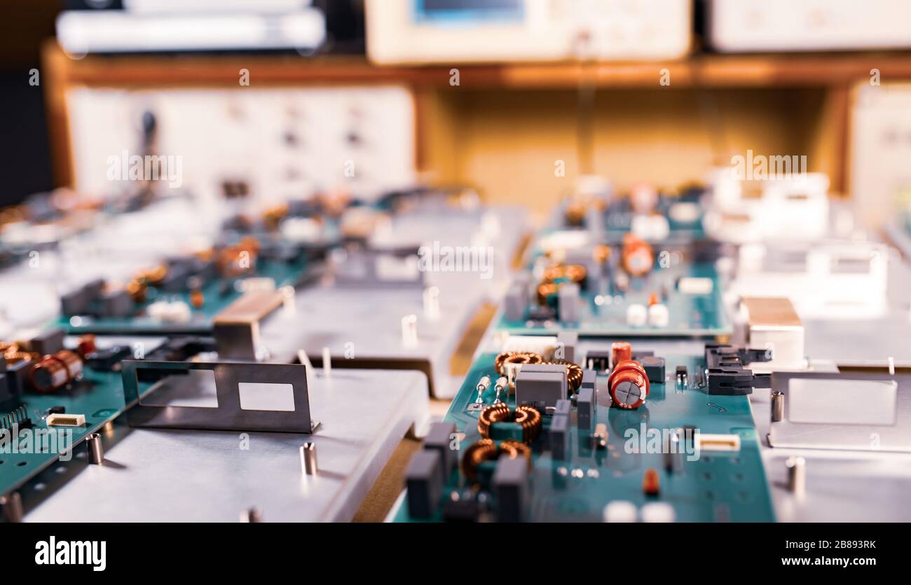 Microcircuits and components lie on metal plates during the production ...