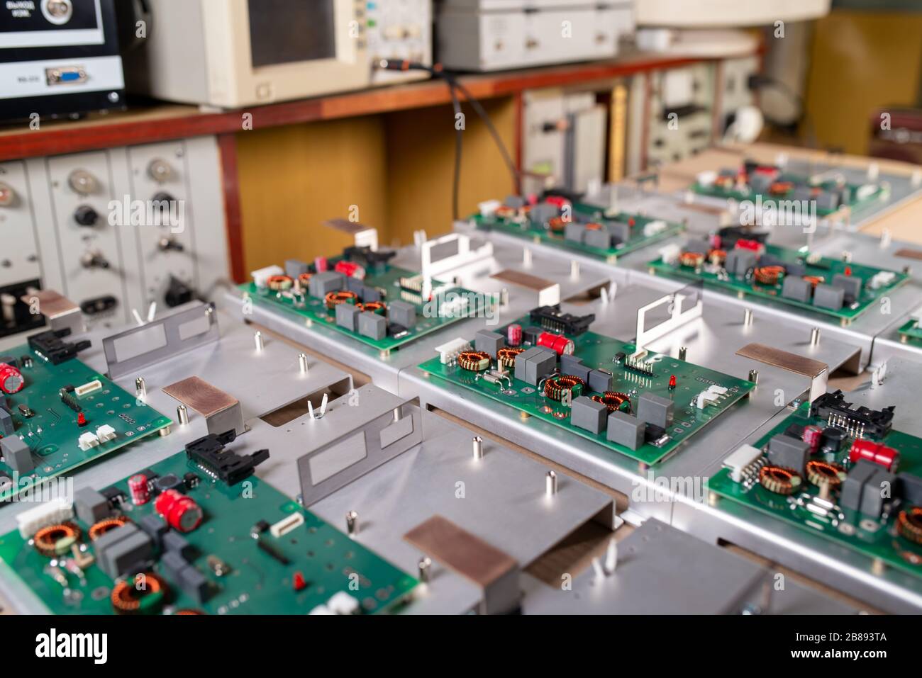 Microcircuits and components lie on metal plates during the production ...