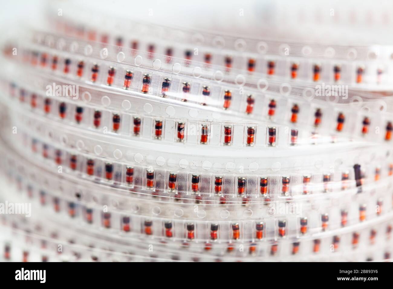 Photo of electrical part plastic tape with capacitors for electronic ...