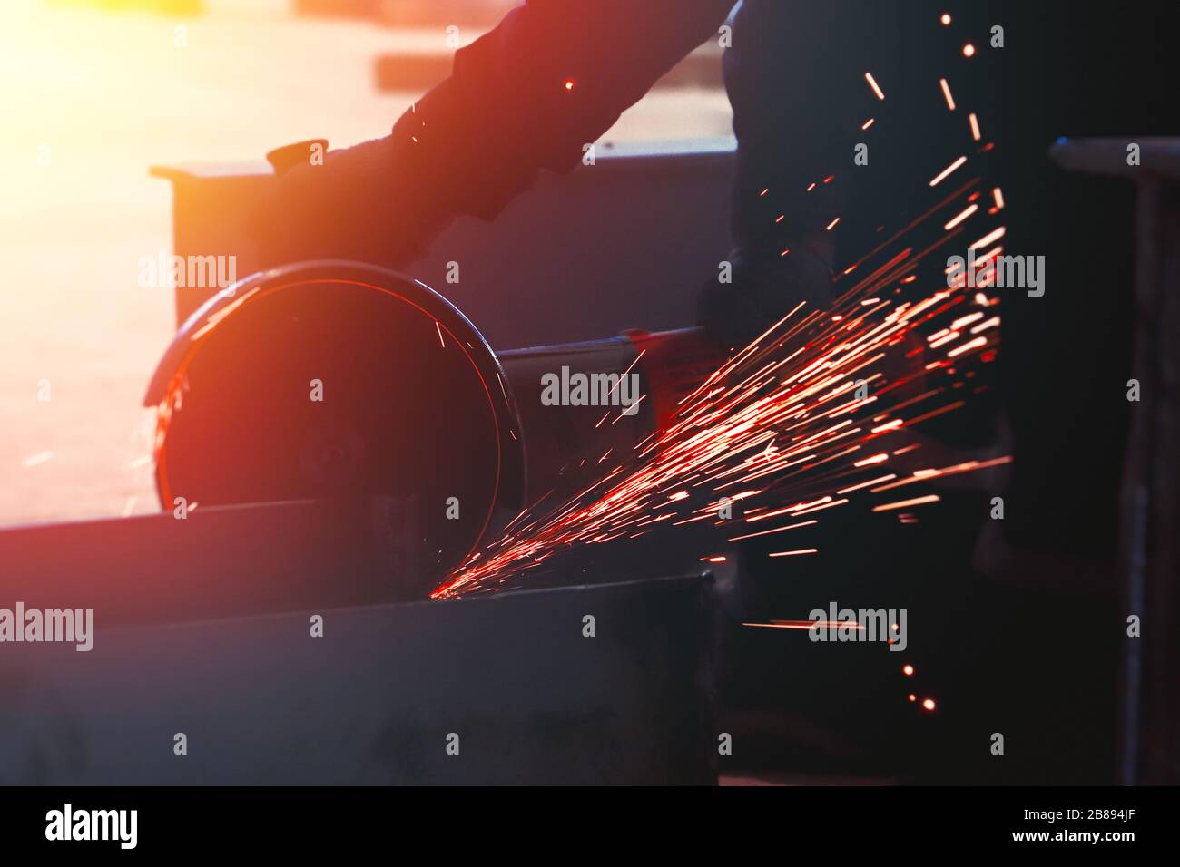 Professional worker cuts metal by angle grinder machine. Fountain of ...