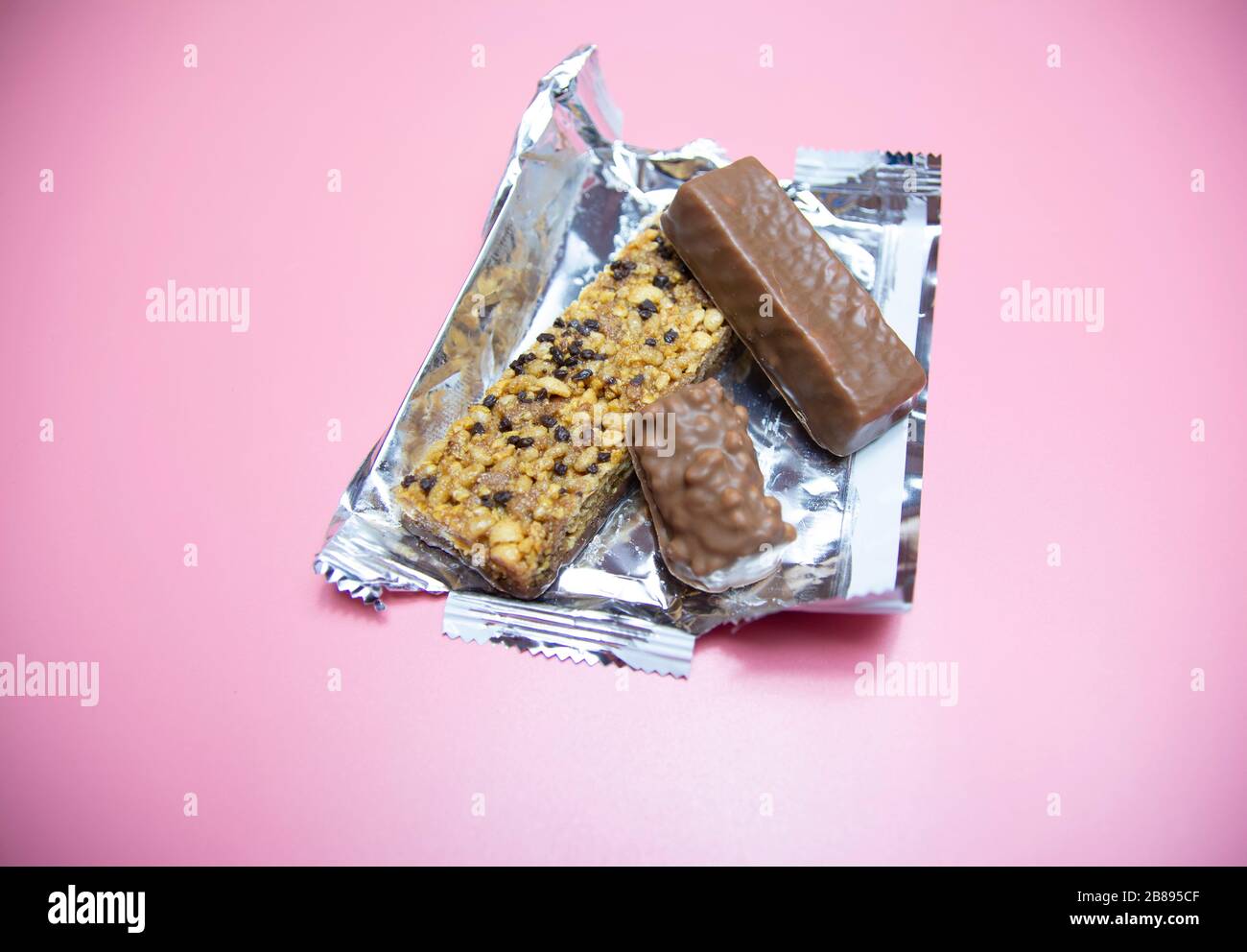 chocolate protein bar healthy food on a pink background Stock Photo - Alamy