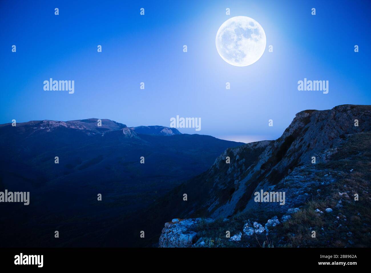 Mesmerizing picturesque mountain landscape with a full moon at night ...