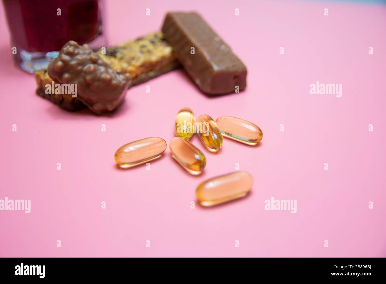 chocolate protein bar with omega 3 healthy food on a pink background ...