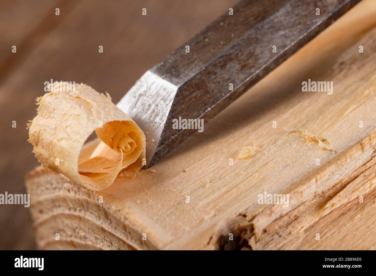 Chisel work in wood and raw wood shavings. Tools and accessories in a ...
