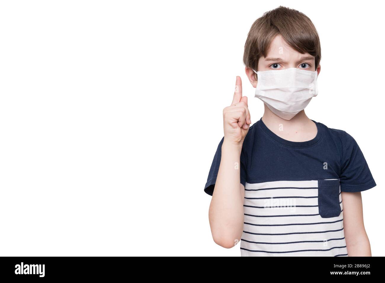 Portrait of kid with face mask pointing finger up, isolated on white ...