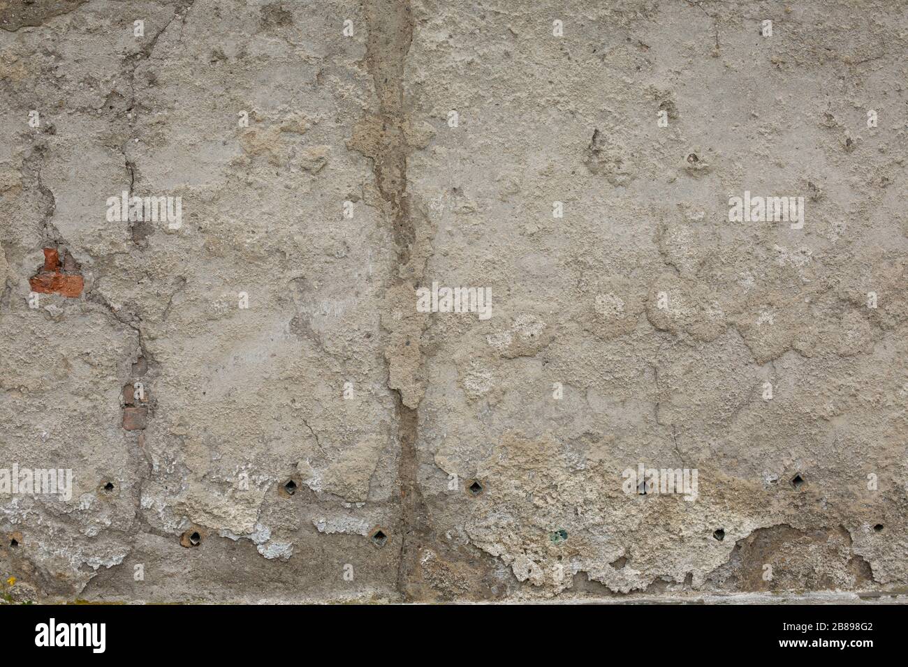 A very old deteriorated and dirty, swollen concrete wall background ...