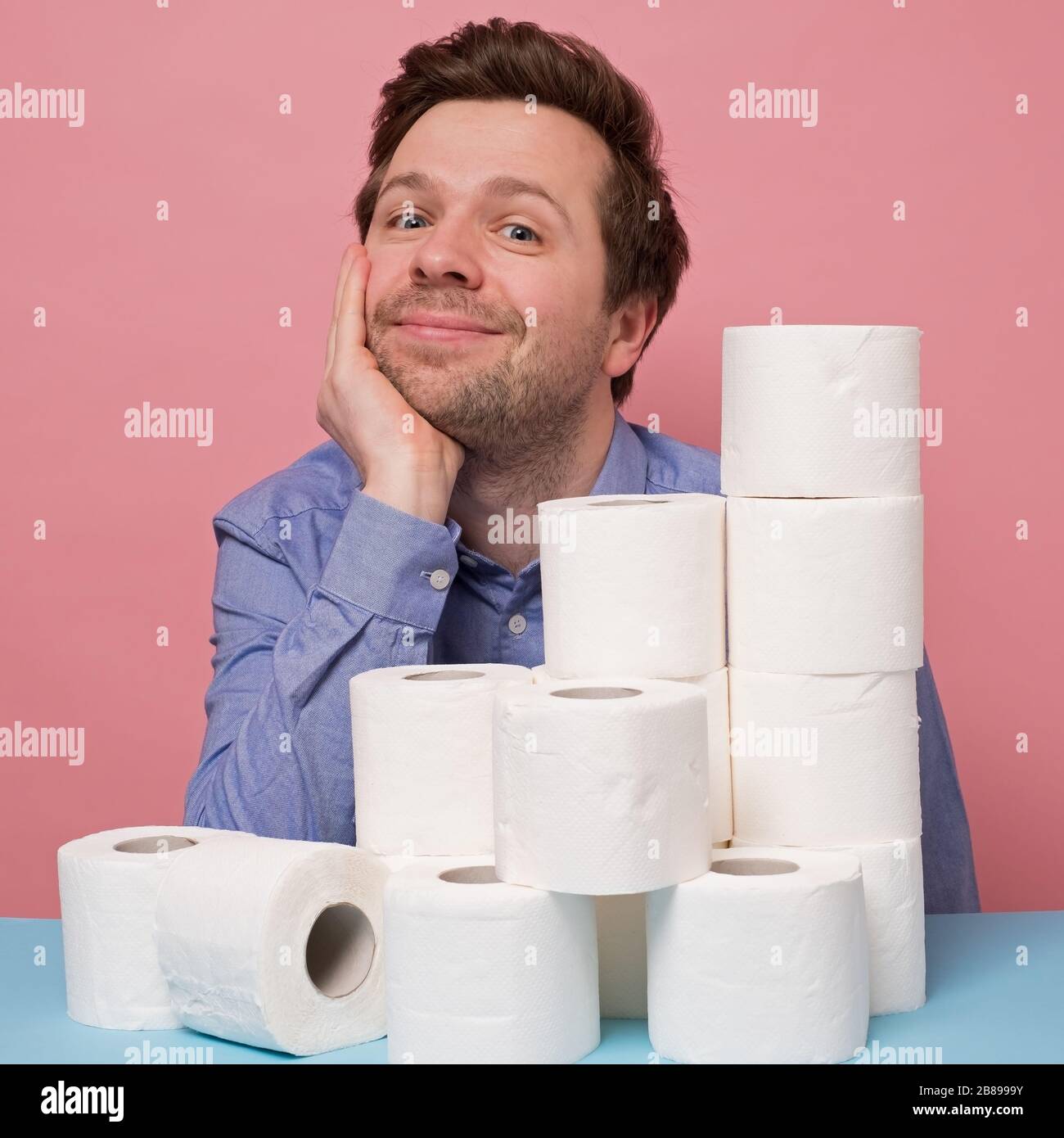 Excited happy caucasian man holding a pile of toilet paper showing ...