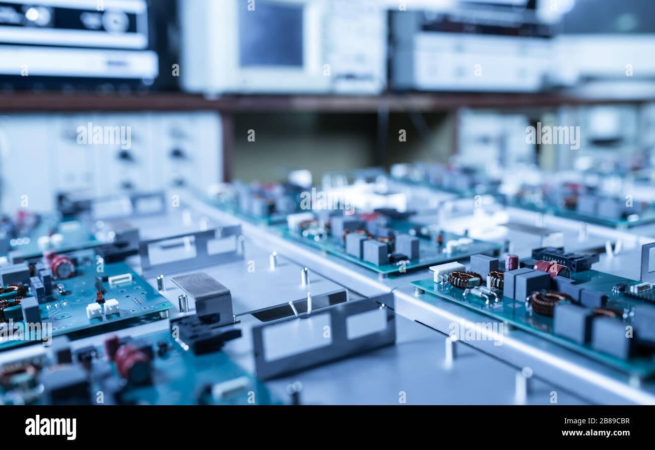 Microcircuits and components lie on metal plates during the production ...