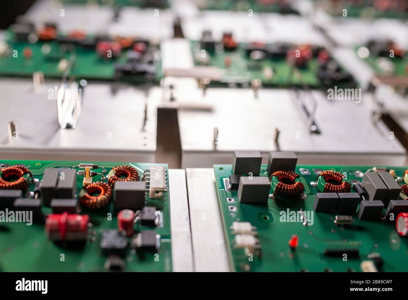 Microcircuits and components lie on metal plates during the production ...