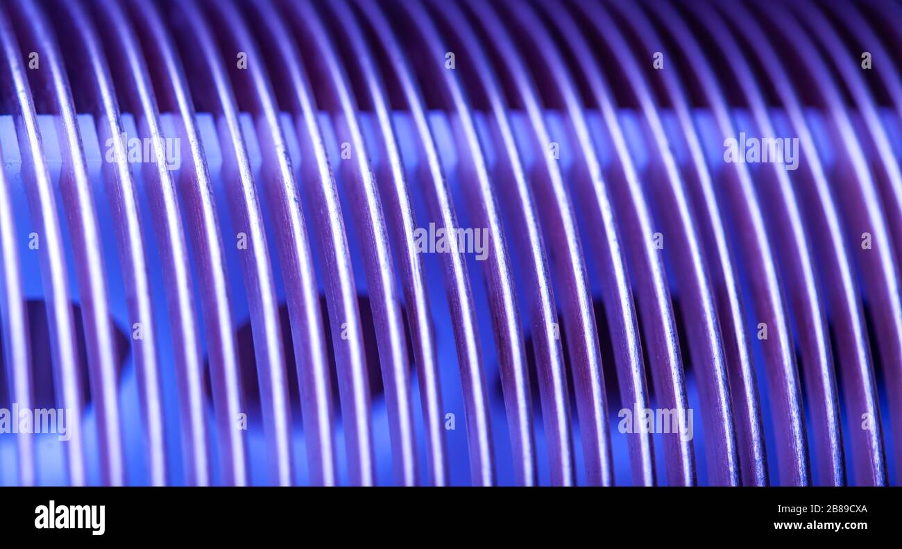 Close-up blue flat steel twisted strip in the production of designer ...