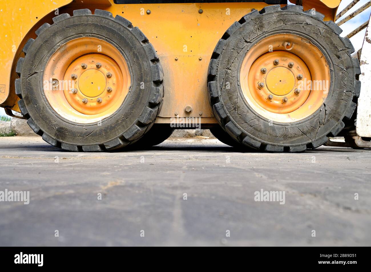 Heavy duty construction machinery, rubber tyres and orange metal body ...