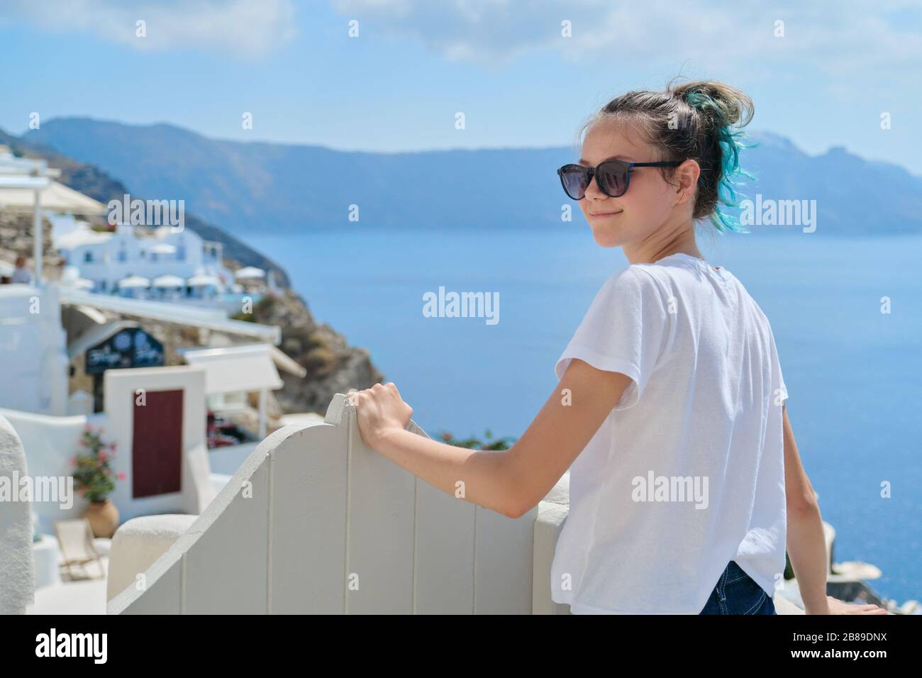 Teenager girl resting on Greek island Santorini, female looking at ...