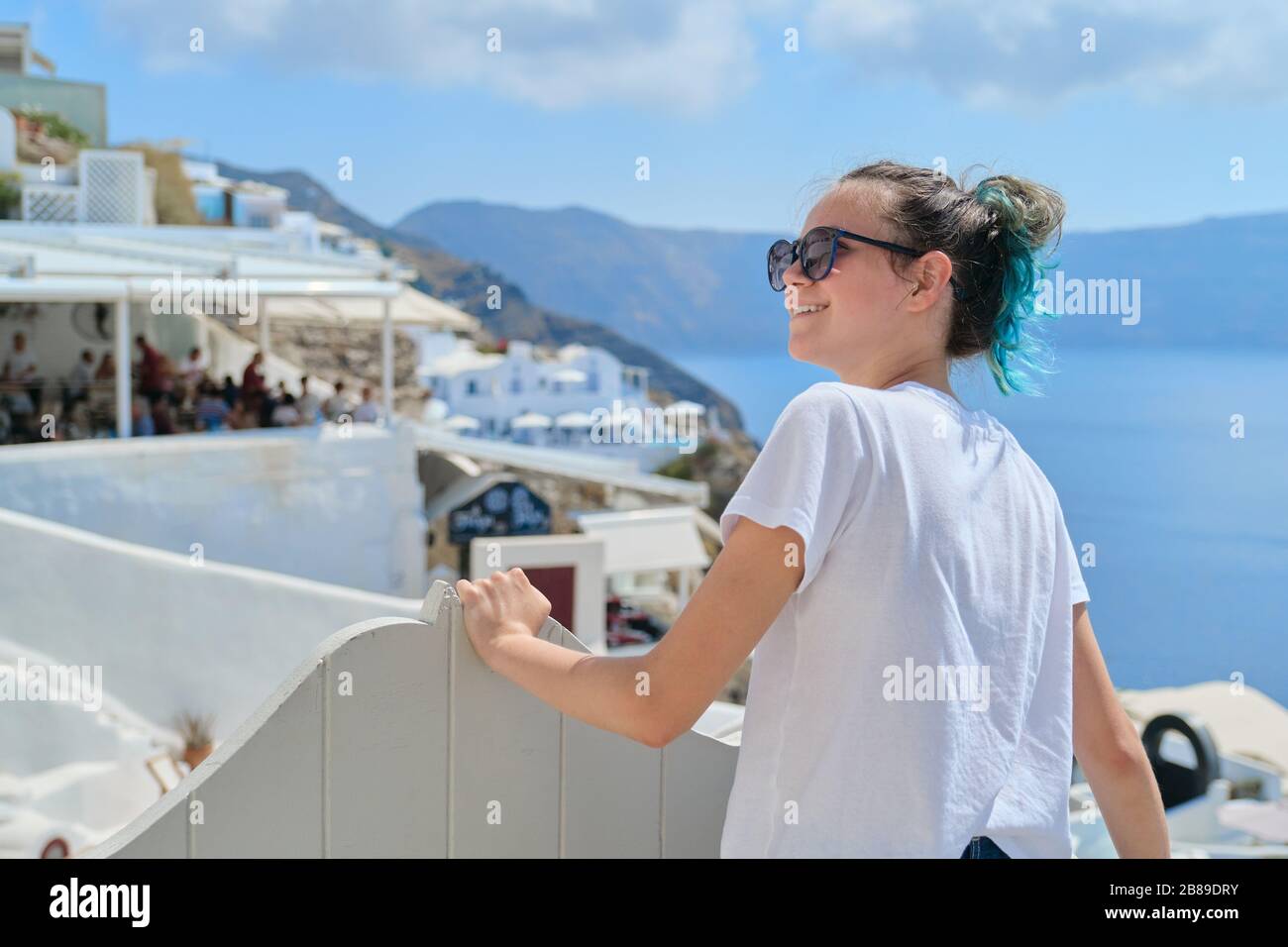 Teenager girl resting on Greek island Santorini, female looking away ...