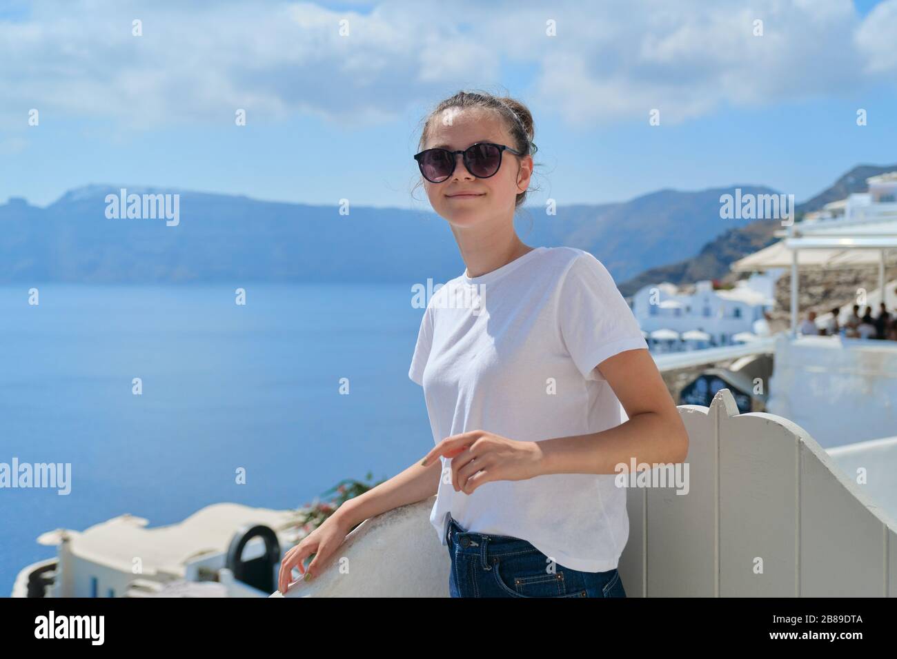 Teenager girl resting on Greek island Santorini, female looking at ...