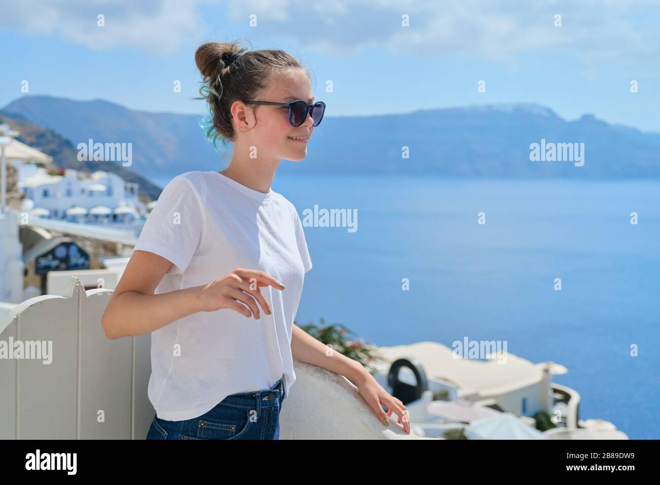 Teenager girl resting on Greek island Santorini, female looking away ...