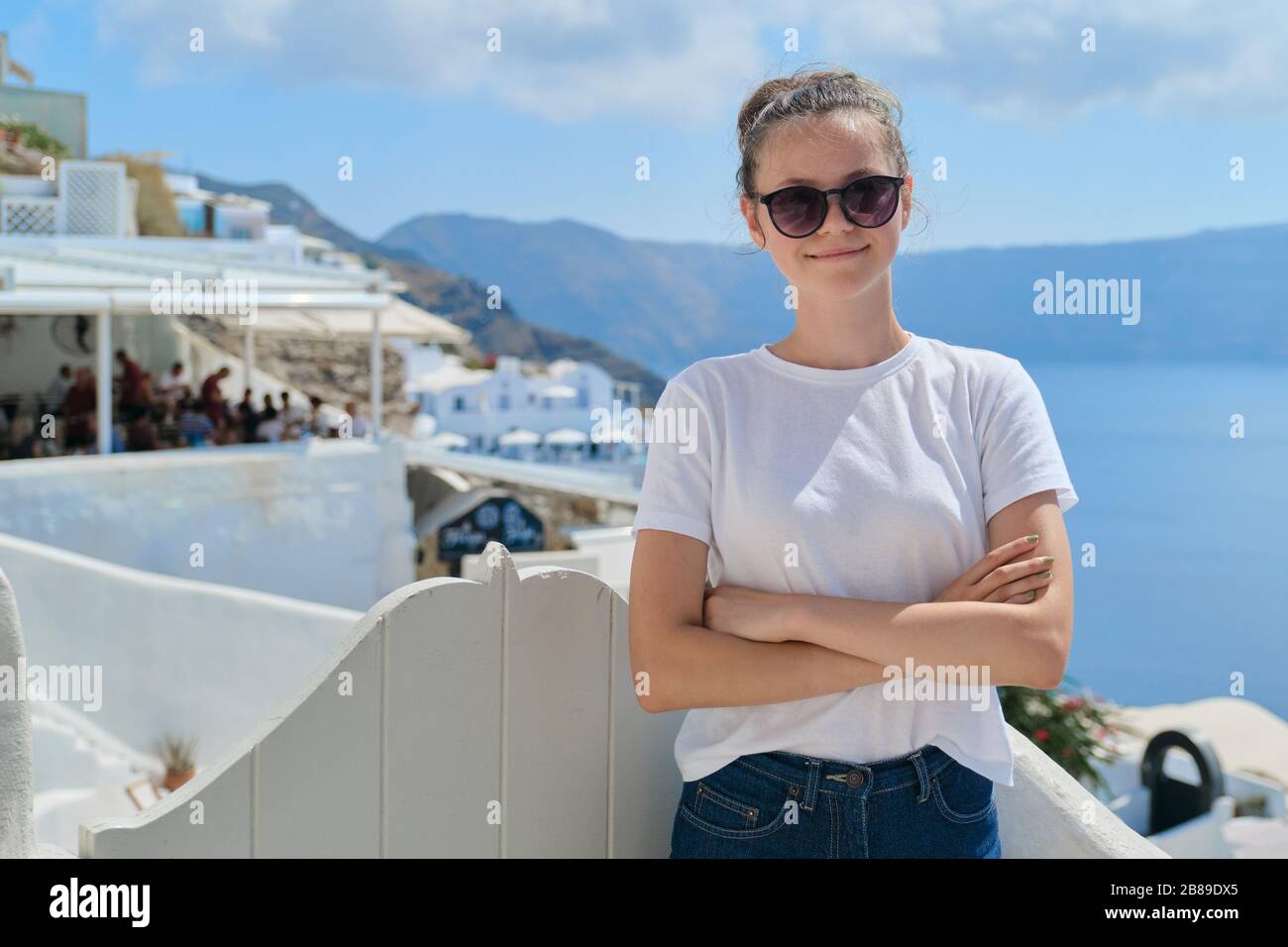 Teenager girl resting on Greek island Santorini, female looking at ...