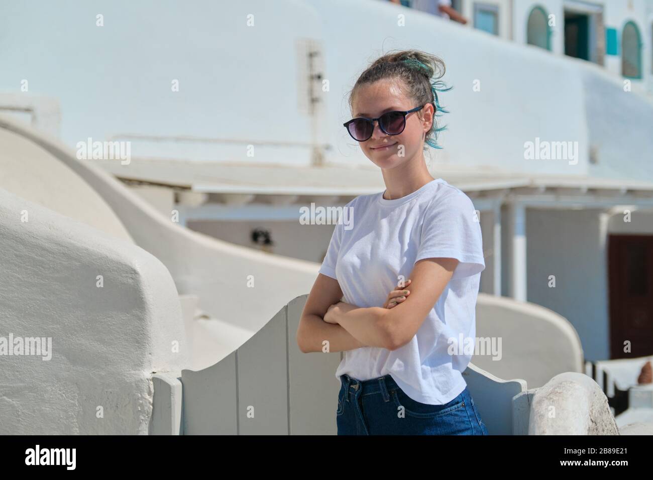 Teenager girl resting on Greek island Santorini, female looking at ...