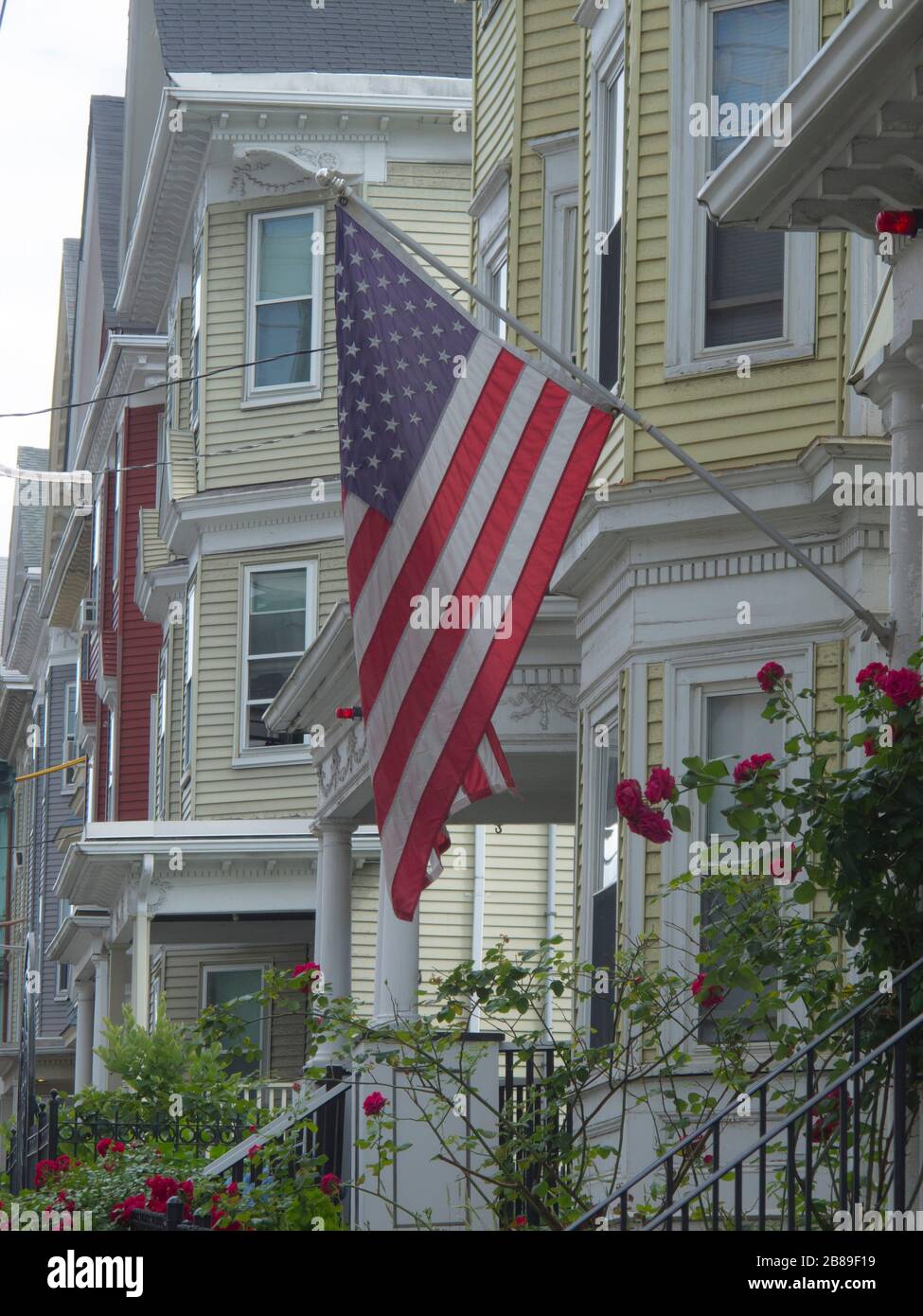 Triple decker housing and the American flag in Mission Hill Boston ...
