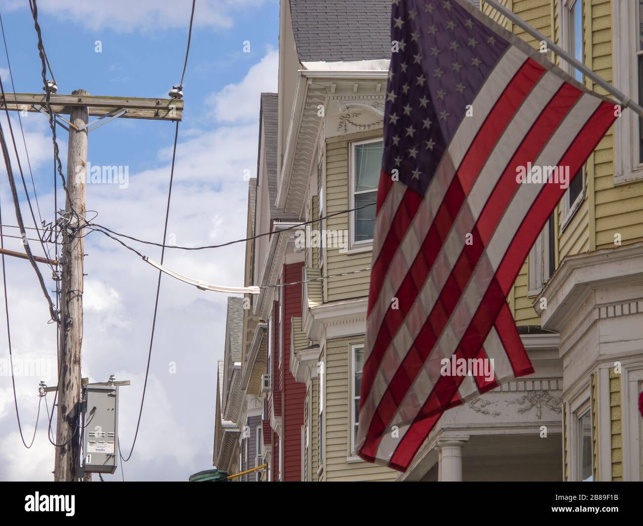 Triple decker housing and the American flag in Mission Hill Boston ...