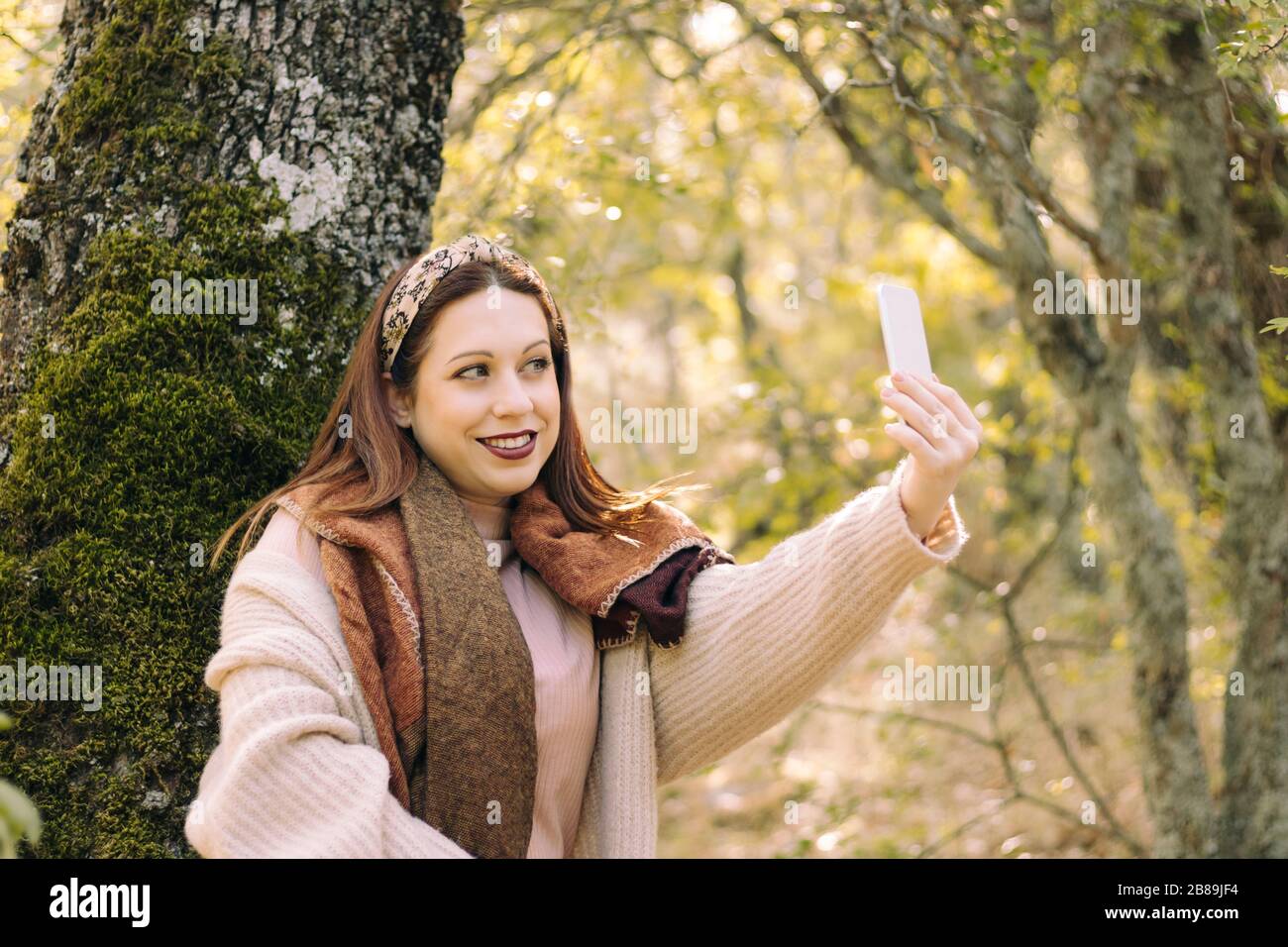 Person leaning against a tree hi-res stock photography and images - Alamy