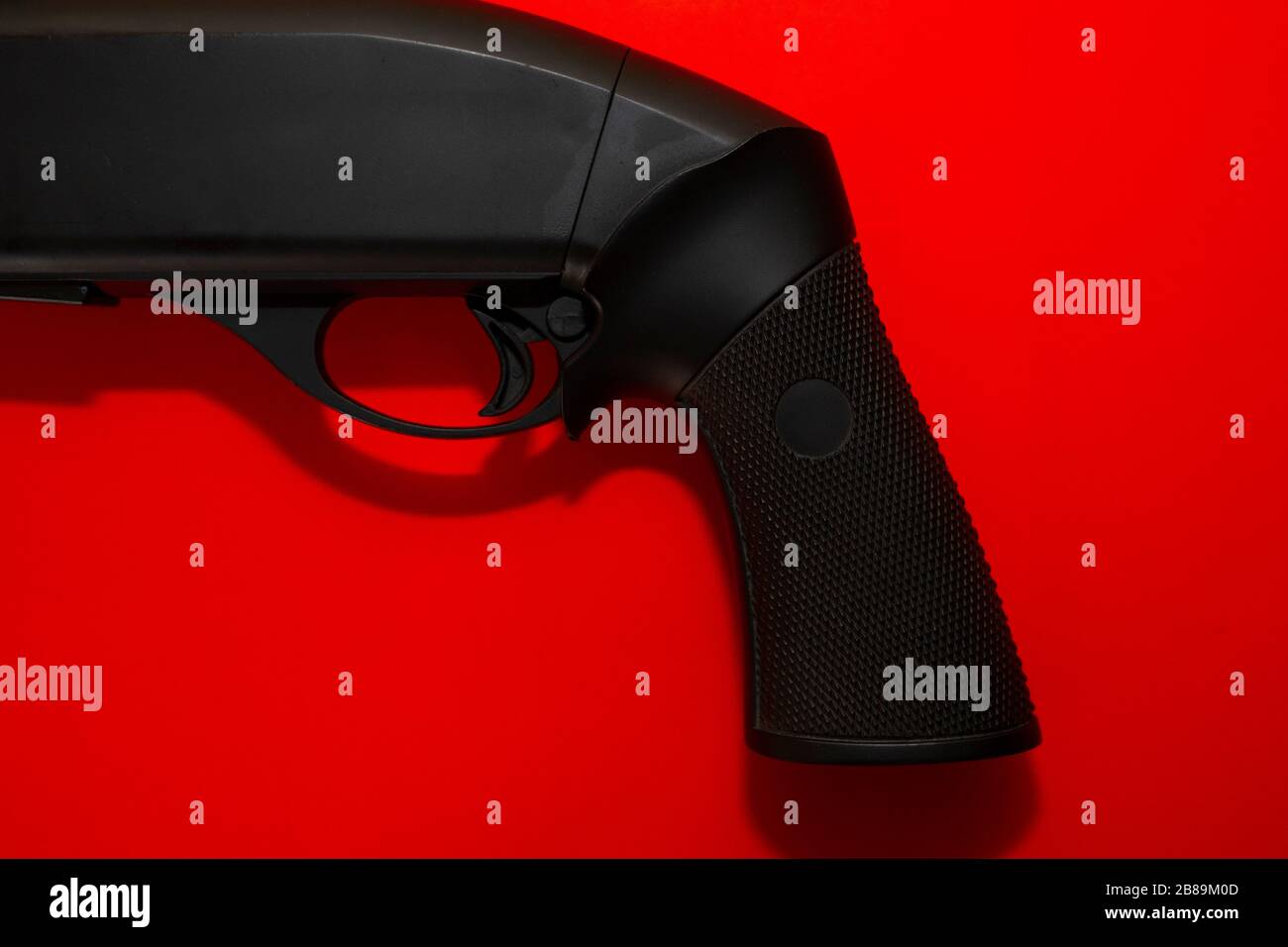 Black shotgun on a red background. Shotgun and weapons concept Stock ...