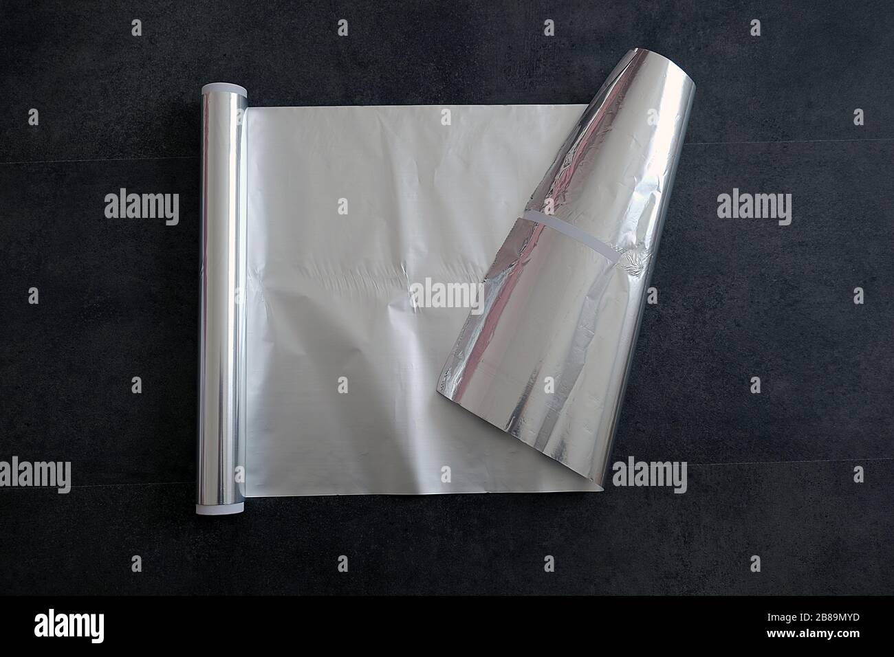 aluminum foil, rolled aluminum foil, close-up on a black background ...